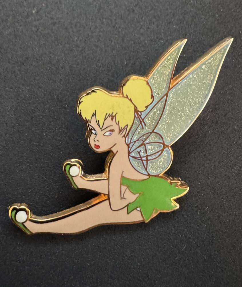 Tinker Bell - Tinker bell sitting with her hands on hip looking over ...